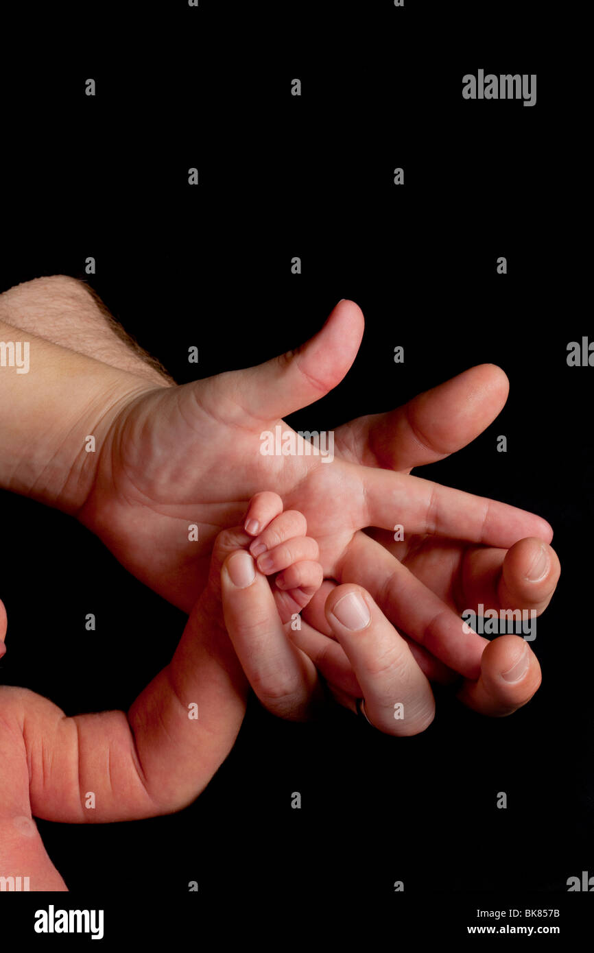 Newborn hand with parent hands Stock Photo - Alamy