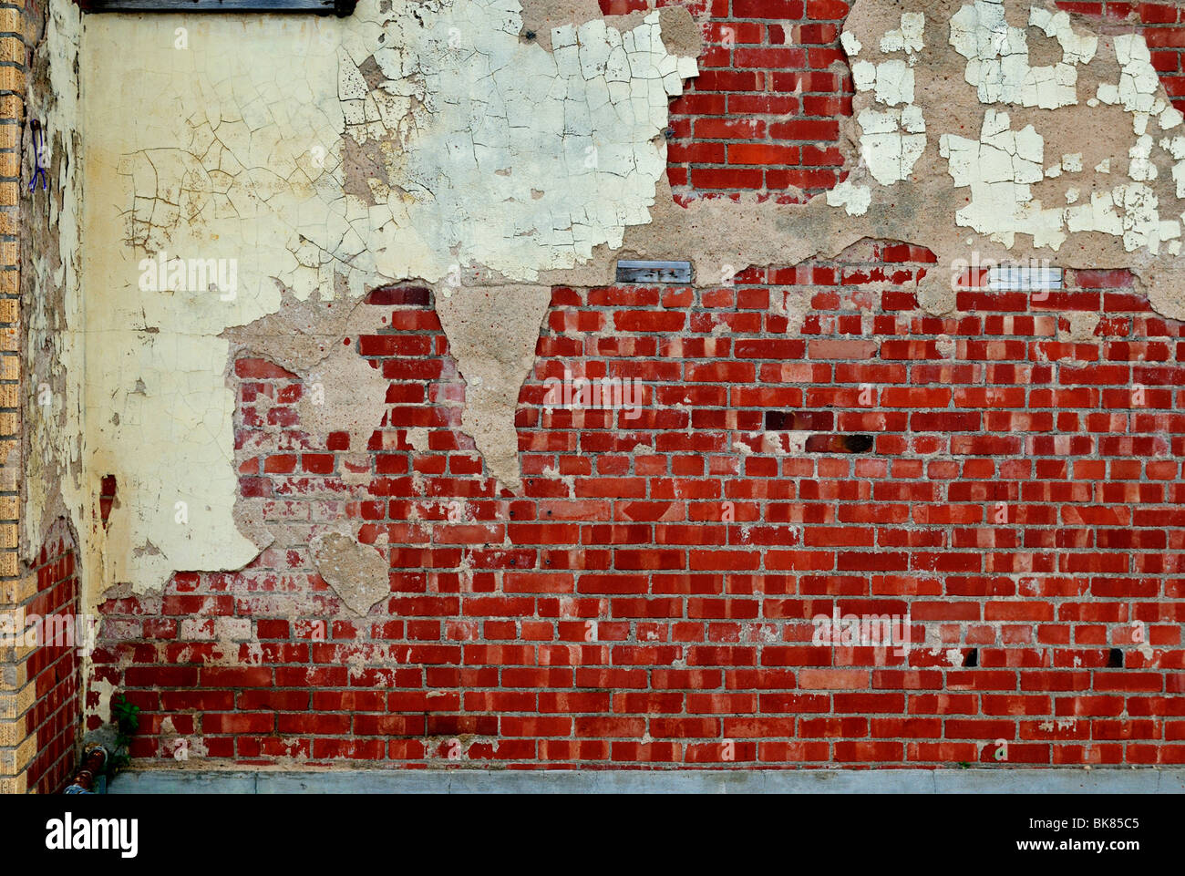 An old, red brick wall with cement patches. Suitable for backgrounds ...