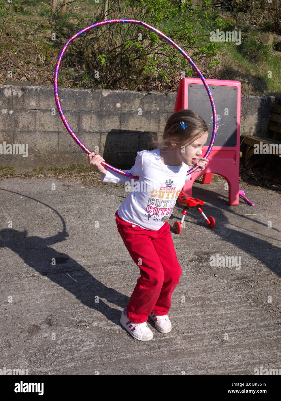 Young 6 year old girl skipping with hoop. England UK Stock Photo - Alamy