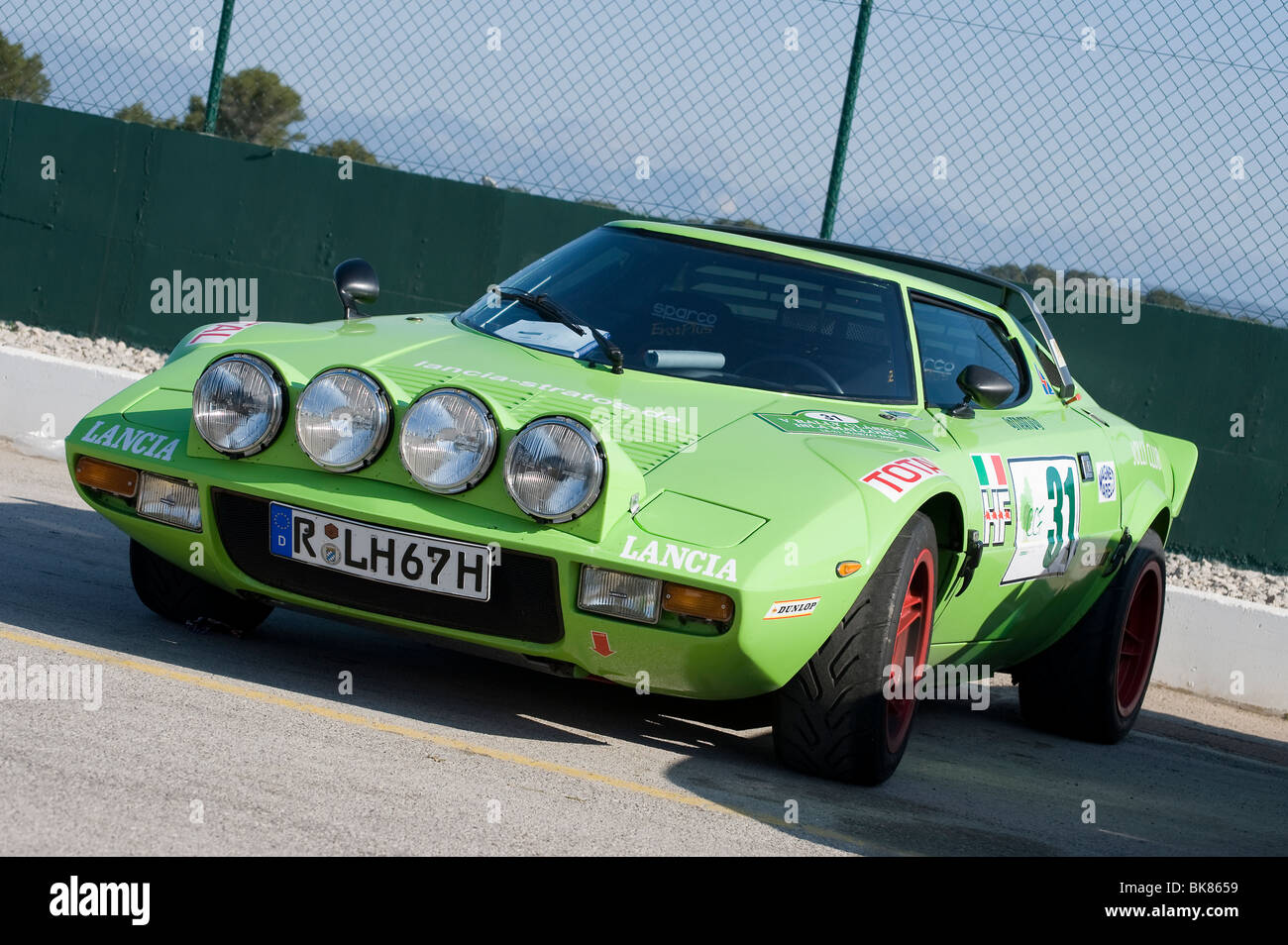 Green 1974 Lancia Stratos classic sports car taking part in a rally in ...