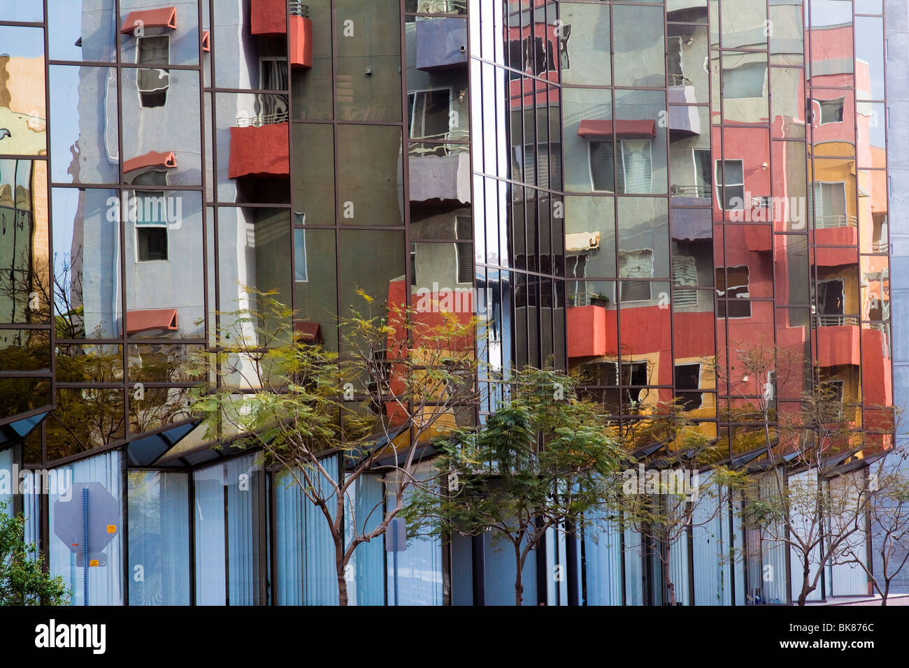 Mirror windows reflecting a colorful modern residential building in ...