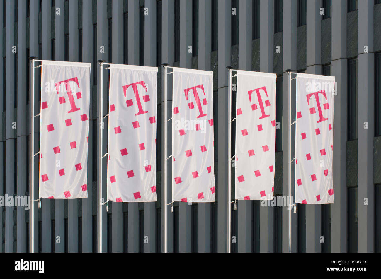 Five Telekom flags in front of an office building facade, Deutsche ...