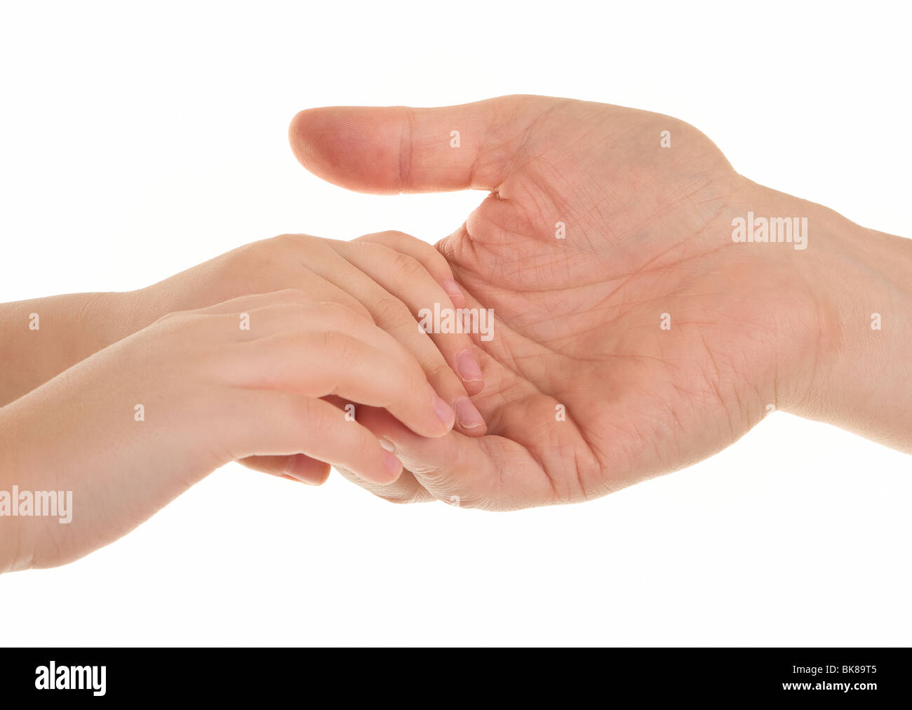 a handshake, young (child) hands hug a adult hand Stock Photo - Alamy