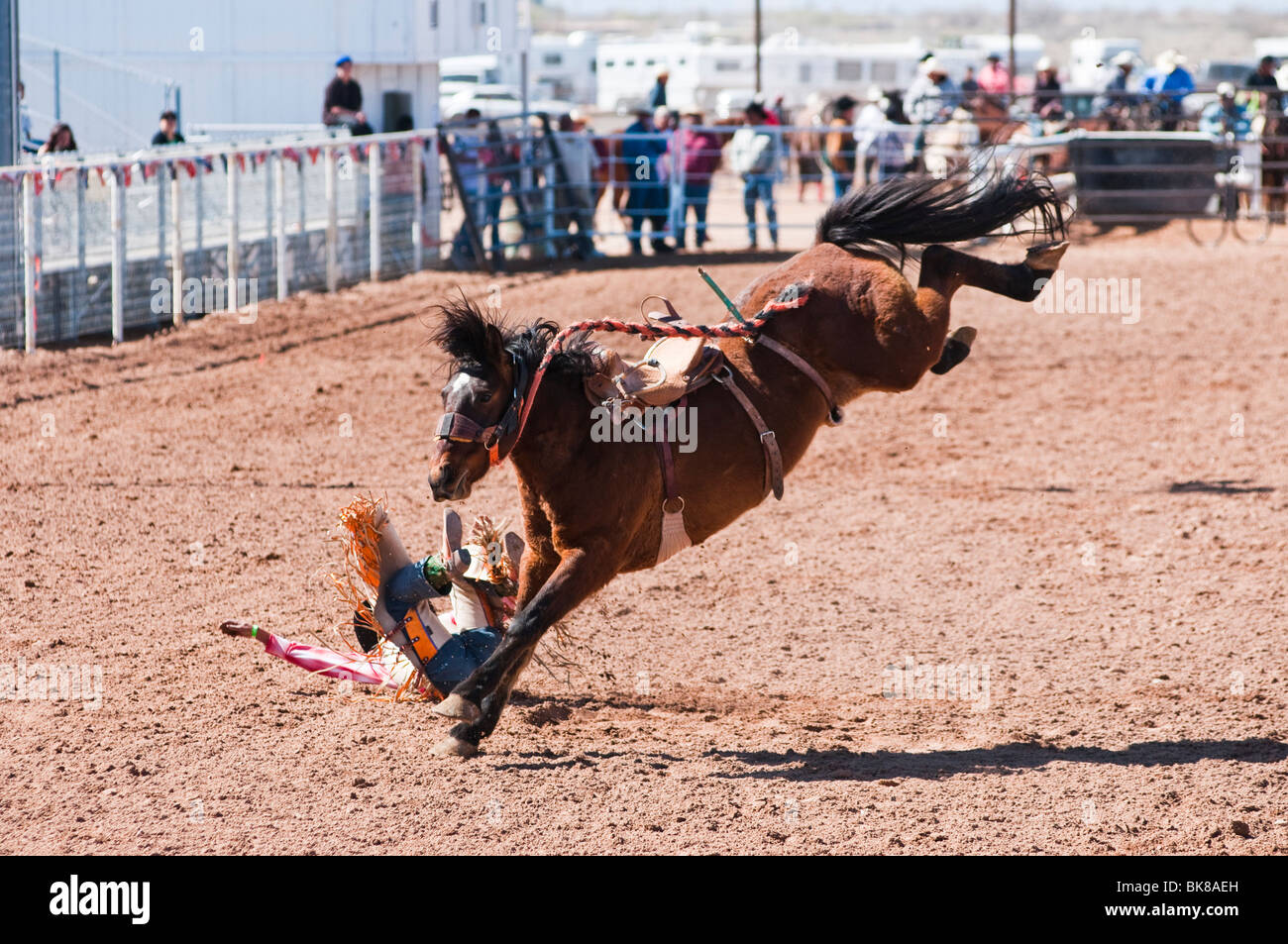 a cowboy competes in the saddle bronc riding event during the O'Odham ...