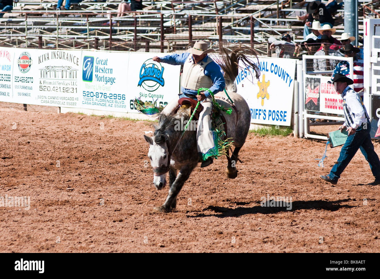 a cowboy competes in the saddle bronc riding event during the O'Odham ...