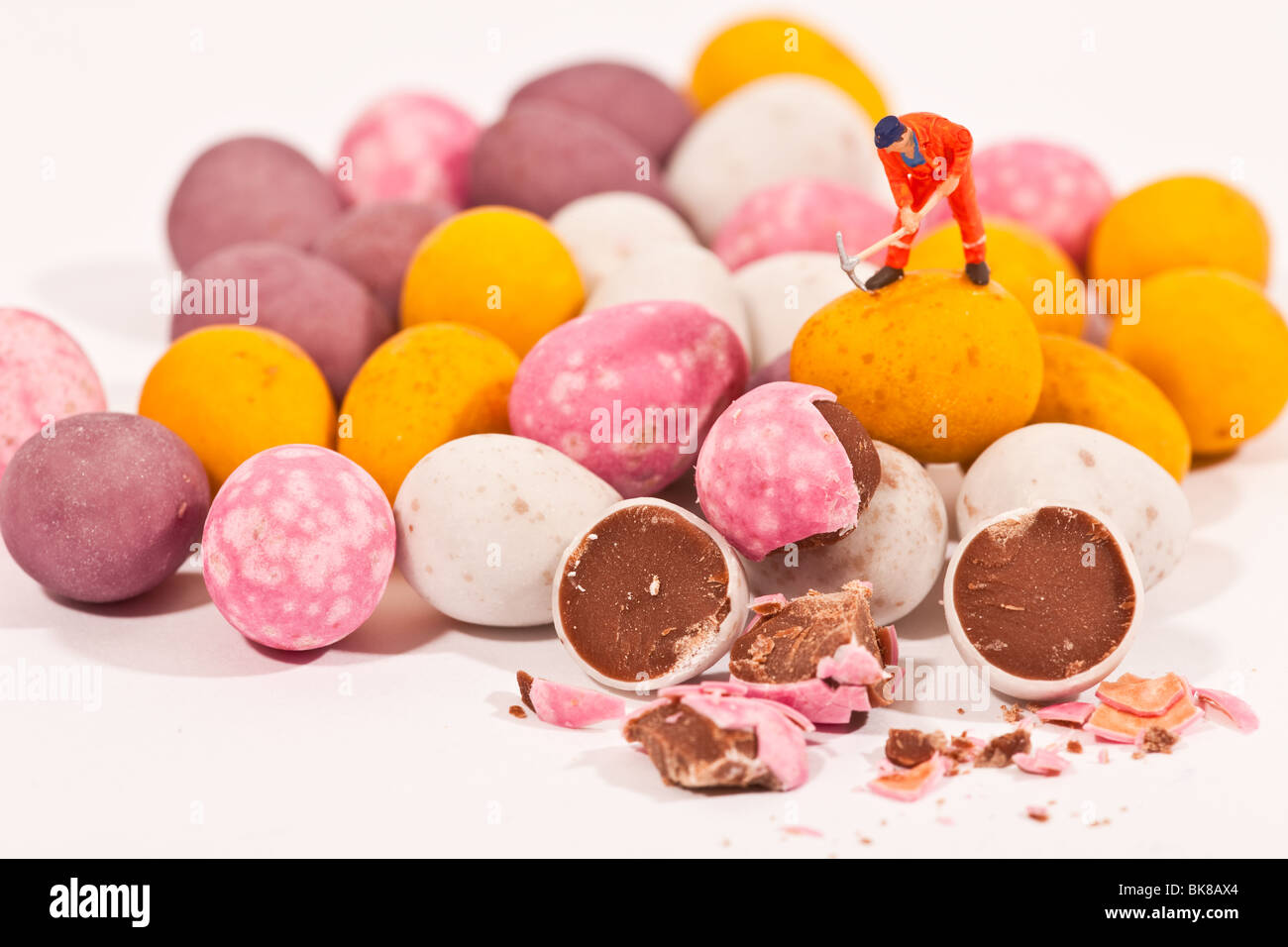 Workman smashing chocolate eggs Stock Photo - Alamy