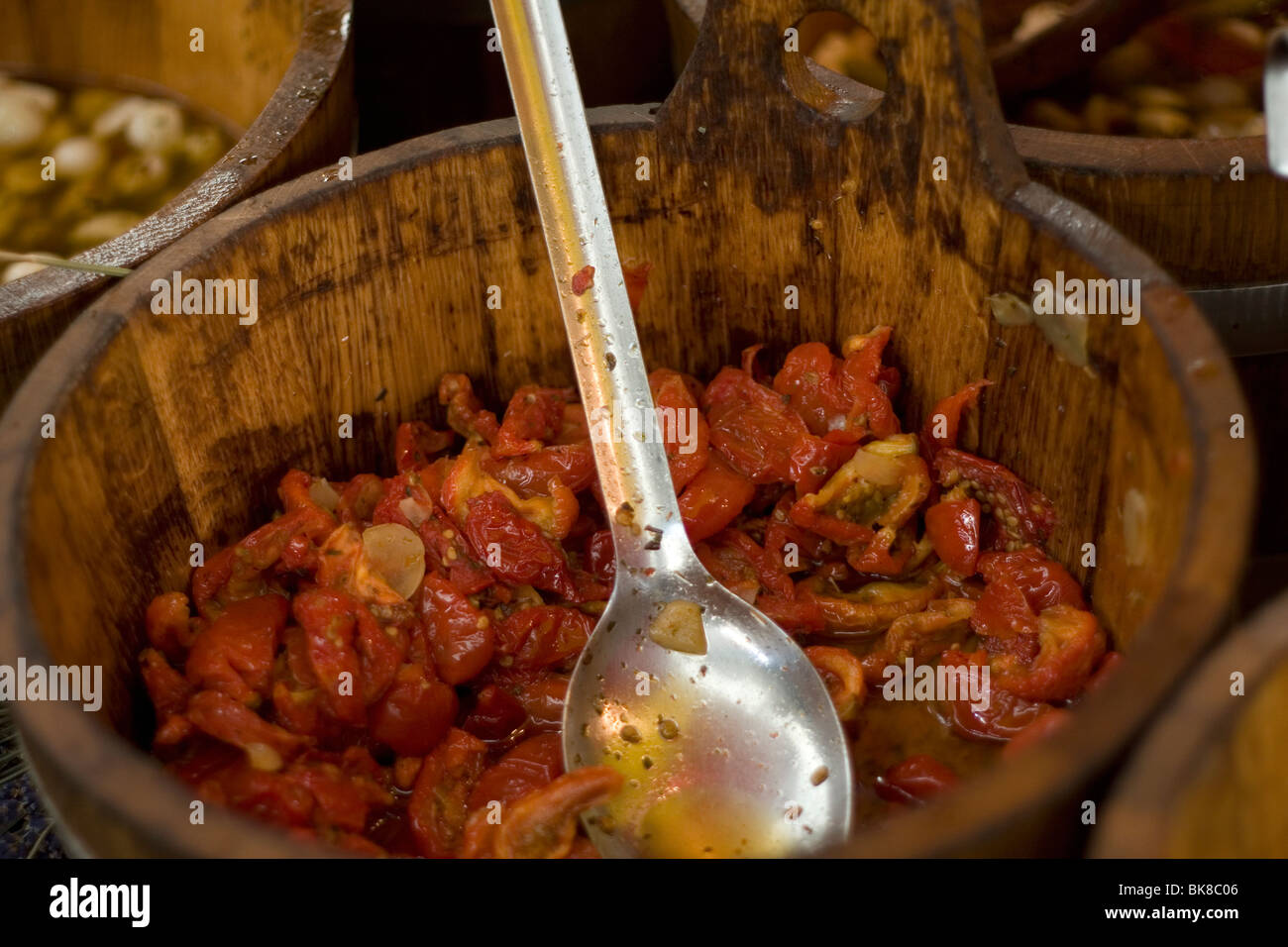 Tomatoes and spoon on display at a market Stock Photo - Alamy