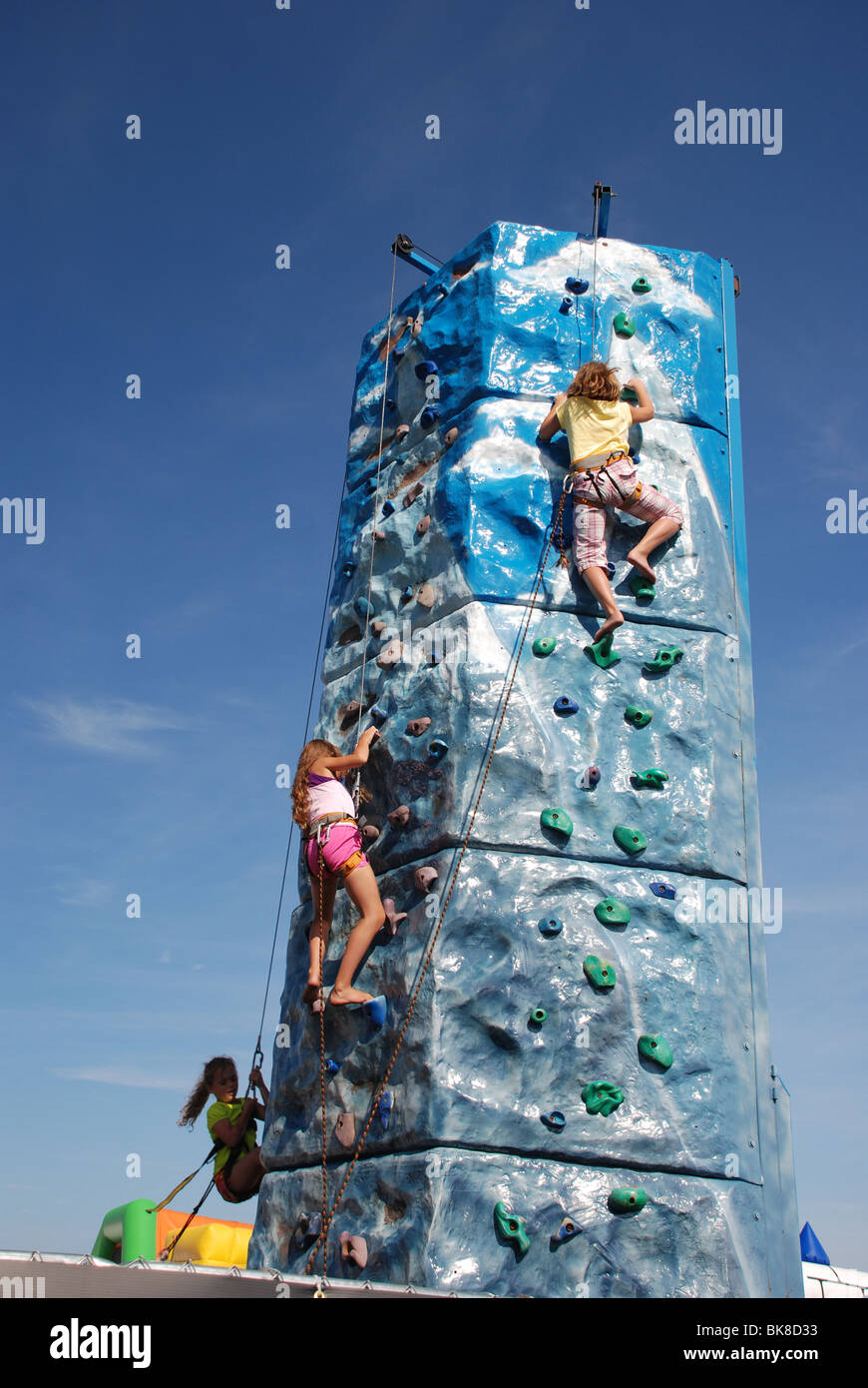 Girls climbing on a wall Stock Photo - Alamy
