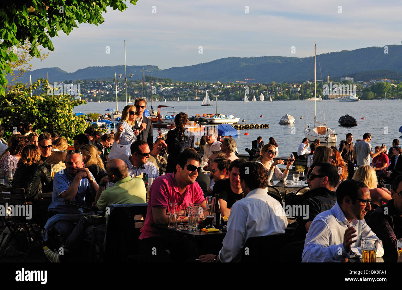 People enjoy a warm spring evening on the lake, Zurich, Switzerland ...