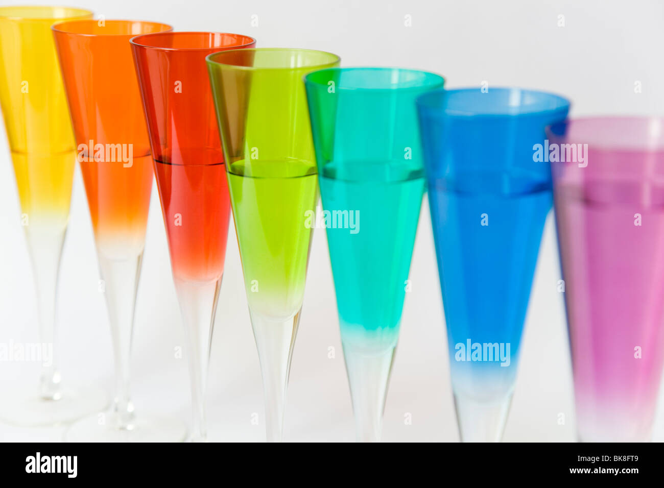 Colored cups with increasing drink inside Stock Photo - Alamy