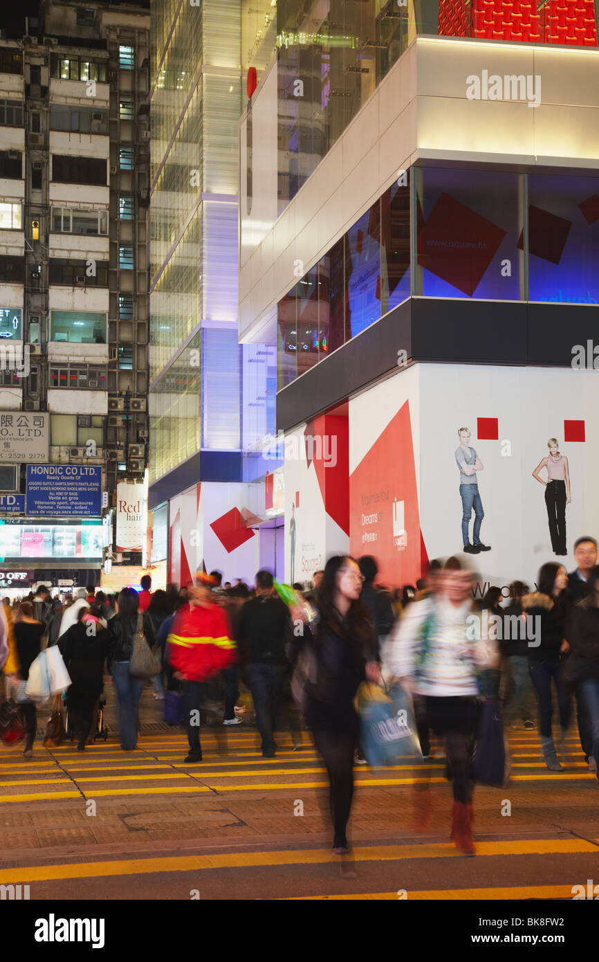 People crossing Nathan Road in front of iSquare shopping mall, Tsim Sha ...