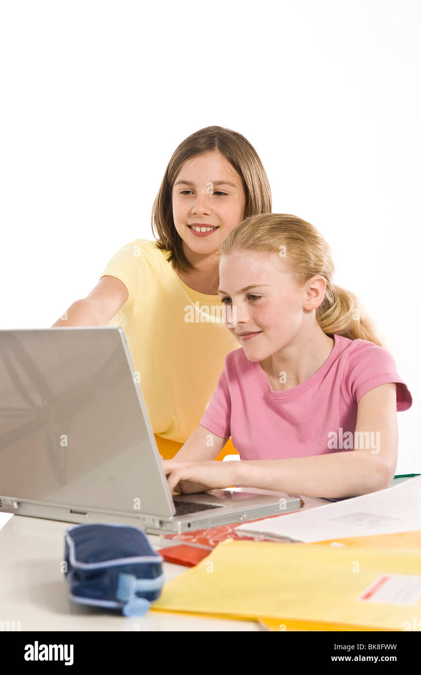 Two girls learning with laptop on desk hi-res stock photography and ...