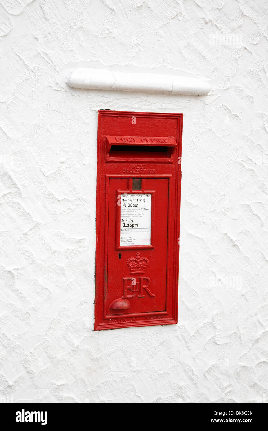 Red post box in white wall Stock Photo - Alamy