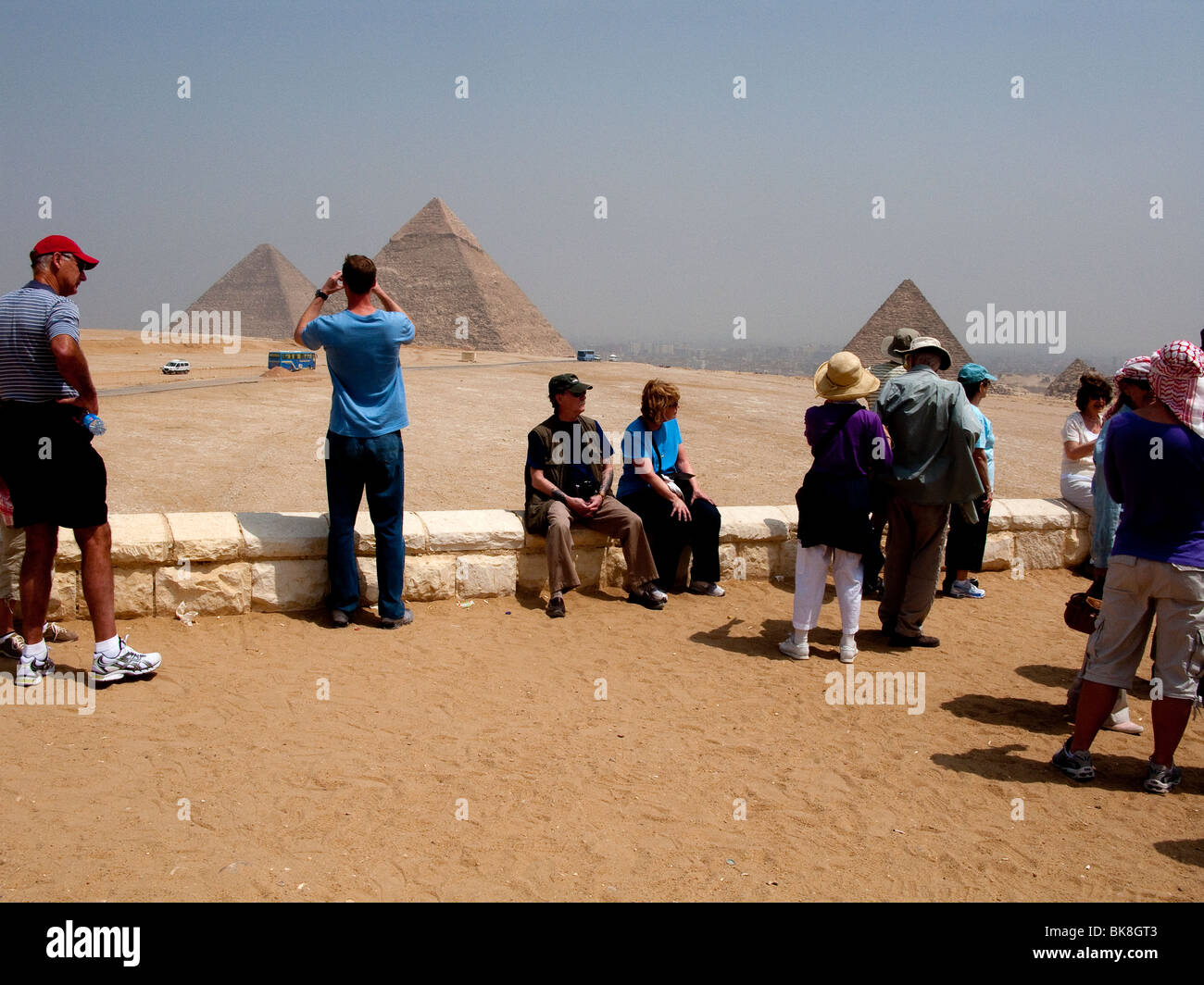Tourists looking at the Great Pyramids, Giza, Cairo, Egypt Stock Photo ...
