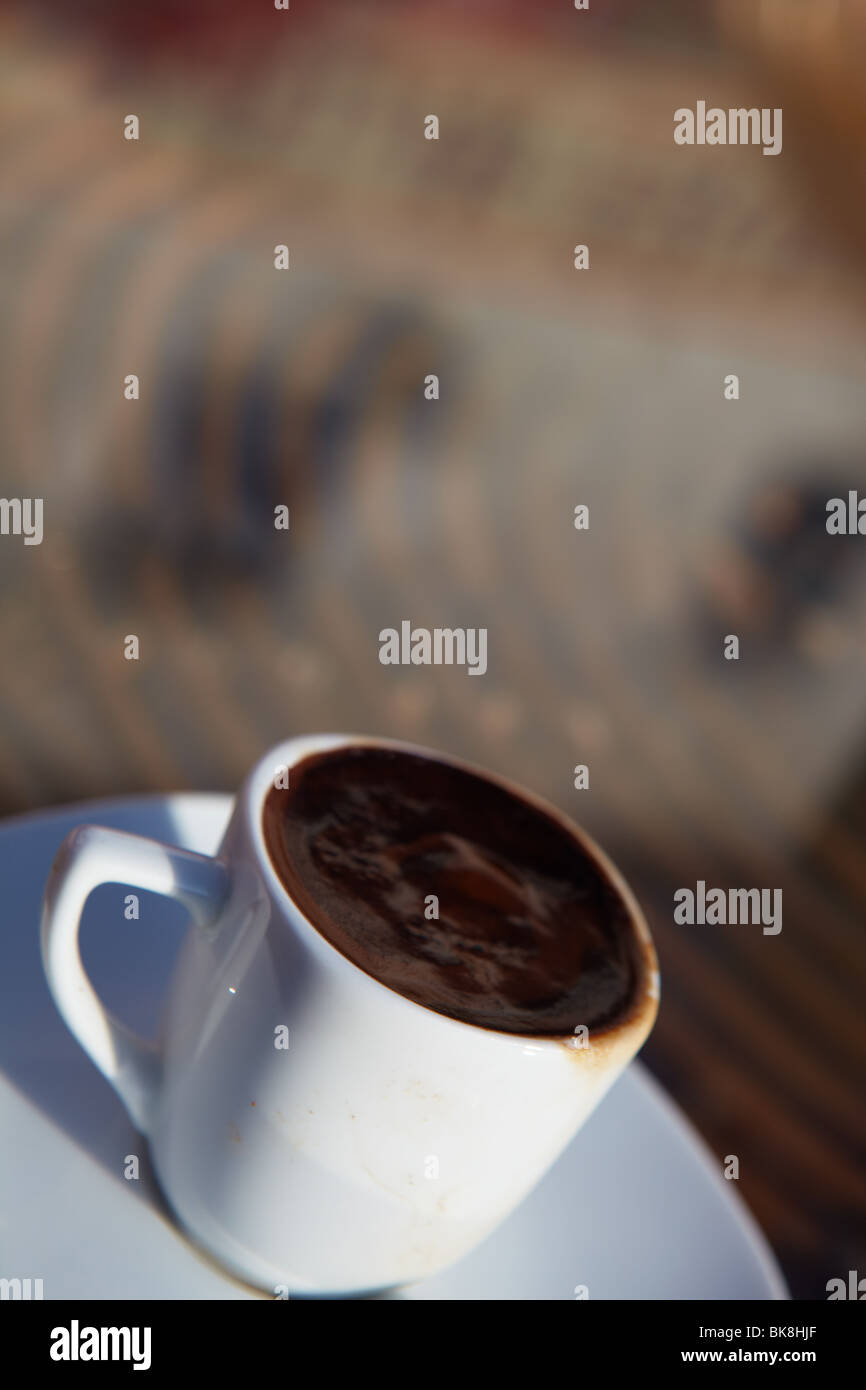 Real turkish coffee in a small white porcelain cup with a traditional ...