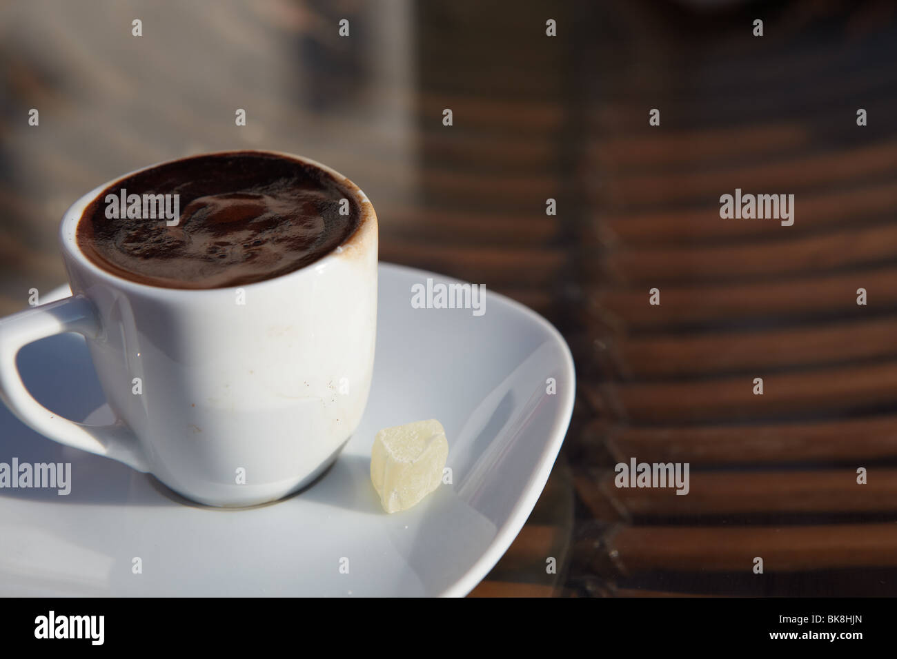 Real turkish coffee in a small white porcelain cup with a traditional ...