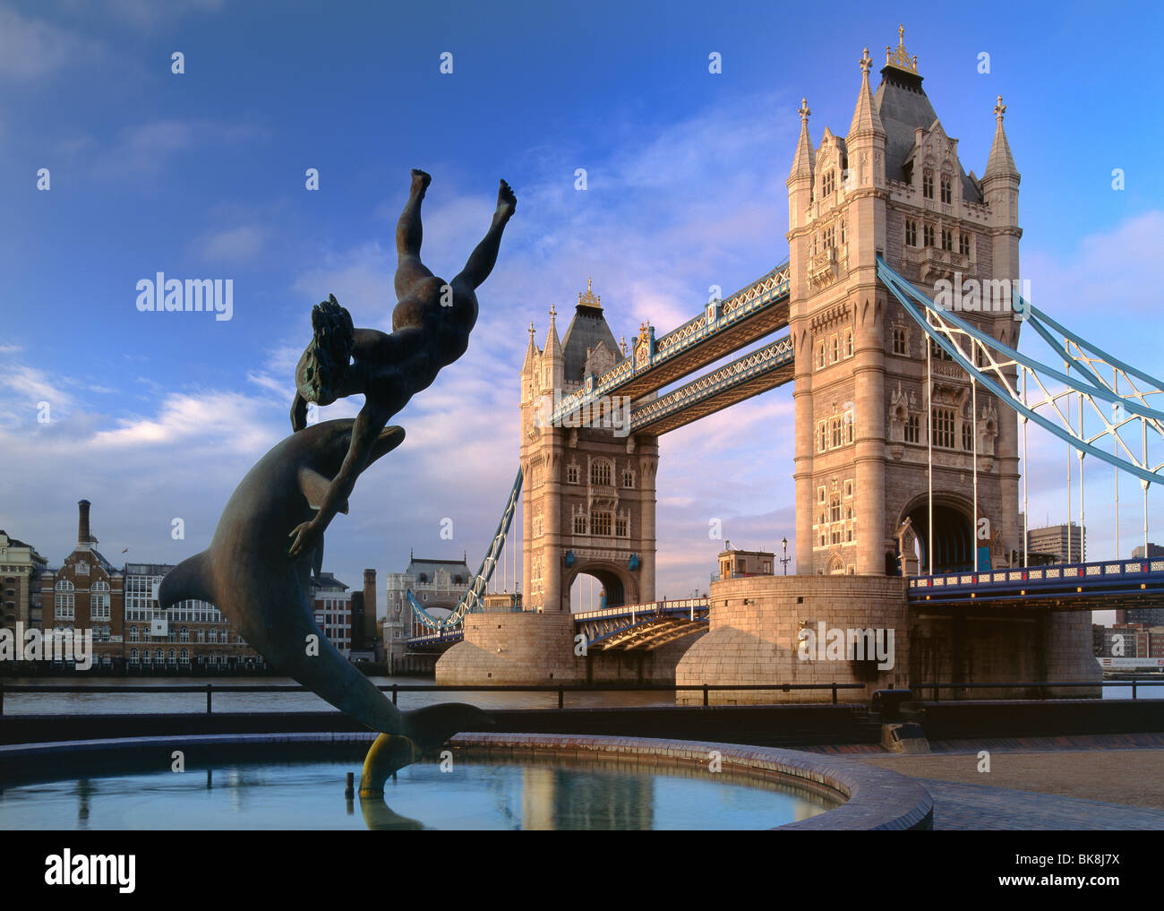 Tower Bridge & Dolphin Statue London in suffused dawn light with statue ...
