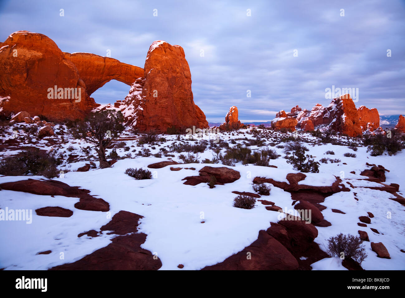 The South Window in Arches National Park, near Moab, Utah, glows a deep ...