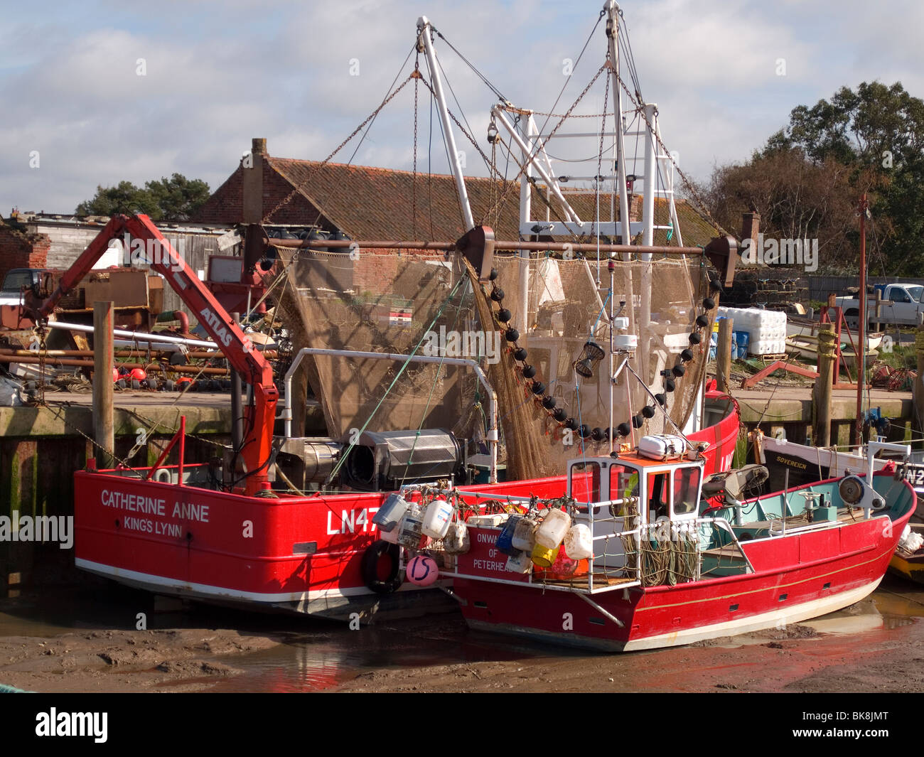 Fishing boats one with hanging beam trawl nets in the harbour at ...
