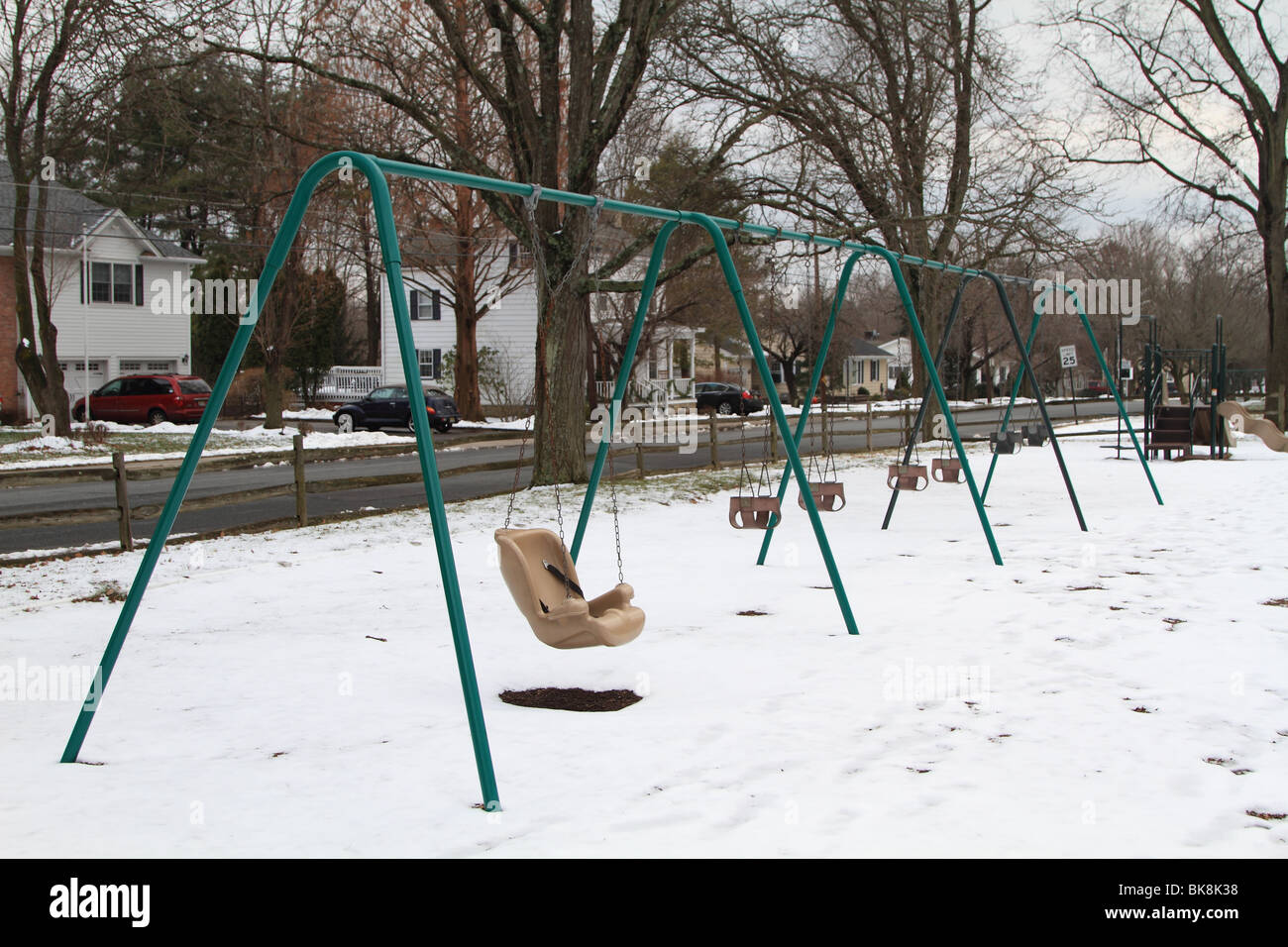 Playground swing set in winter Stock Photo - Alamy
