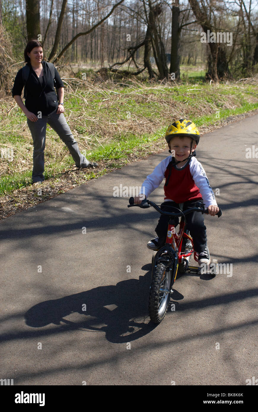Boy Learning to Ride Bicycle with stabilizing wheel bike Stock Photo ...