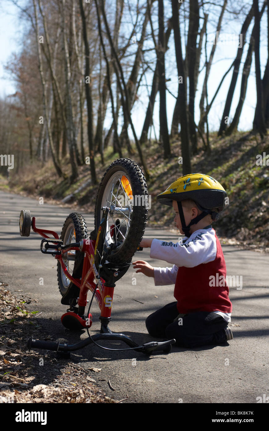 Boy Learning to Ride Bicycle with stabilizing wheel bike Stock Photo ...