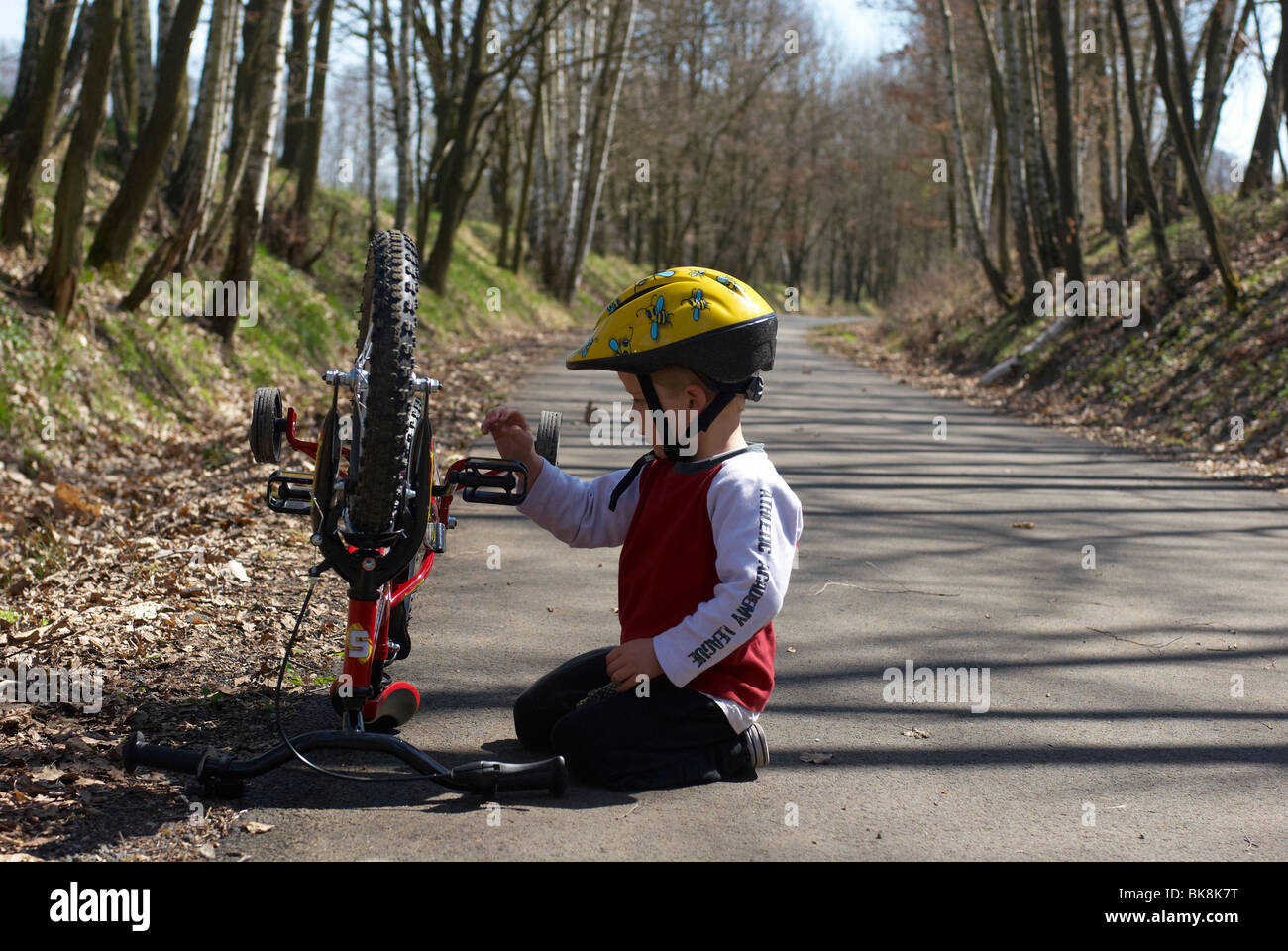 Boy Learning to Ride Bicycle with stabilizing wheel bike Stock Photo ...