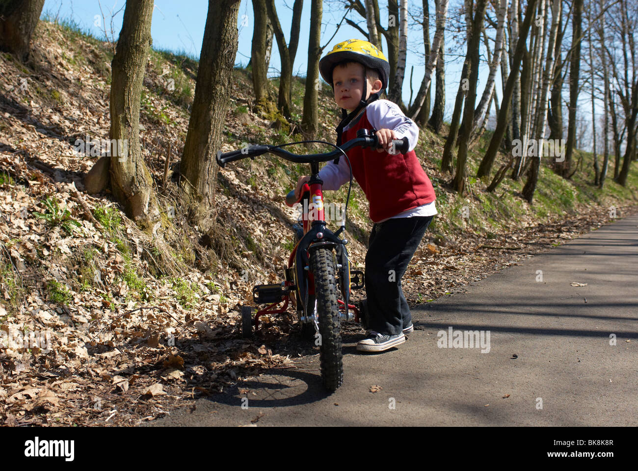 Boy Learning to Ride Bicycle with stabilizing wheel bike Stock Photo ...