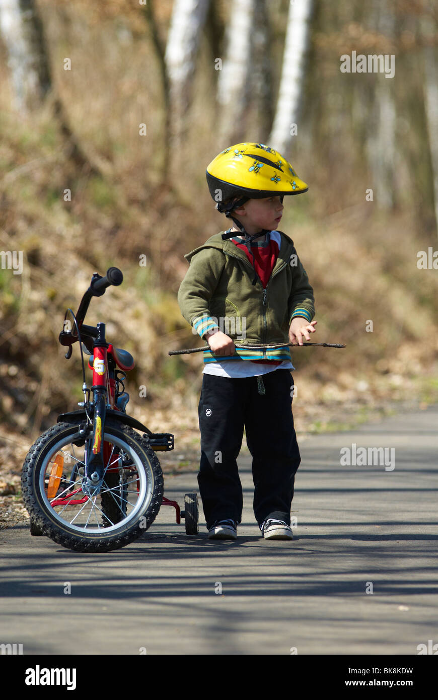 Boy Learning to Ride Bicycle with stabilizing wheel bike Stock Photo ...