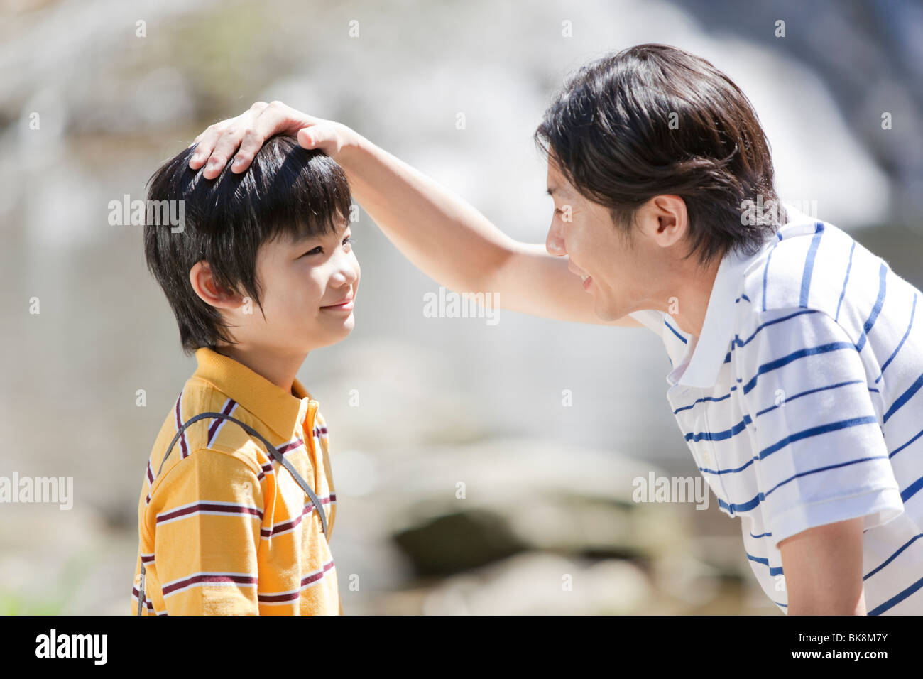 Father Stroking Son's Head Stock Photo - Alamy