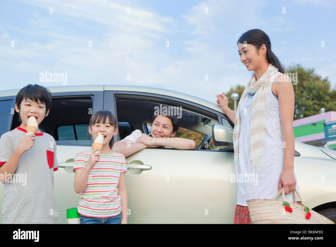 Family Eating Ice Cream at Service Area Stock Photo - Alamy