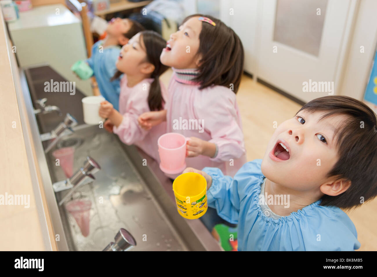 Kindergarten Children Gargling Stock Photo - Alamy