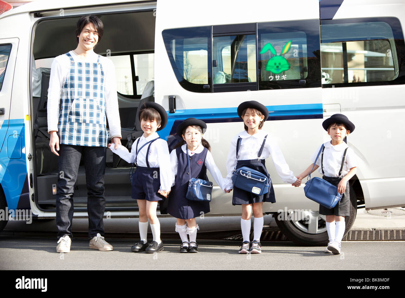 Kindergarten Teacher and Children Standing in front of School Bus Stock ...
