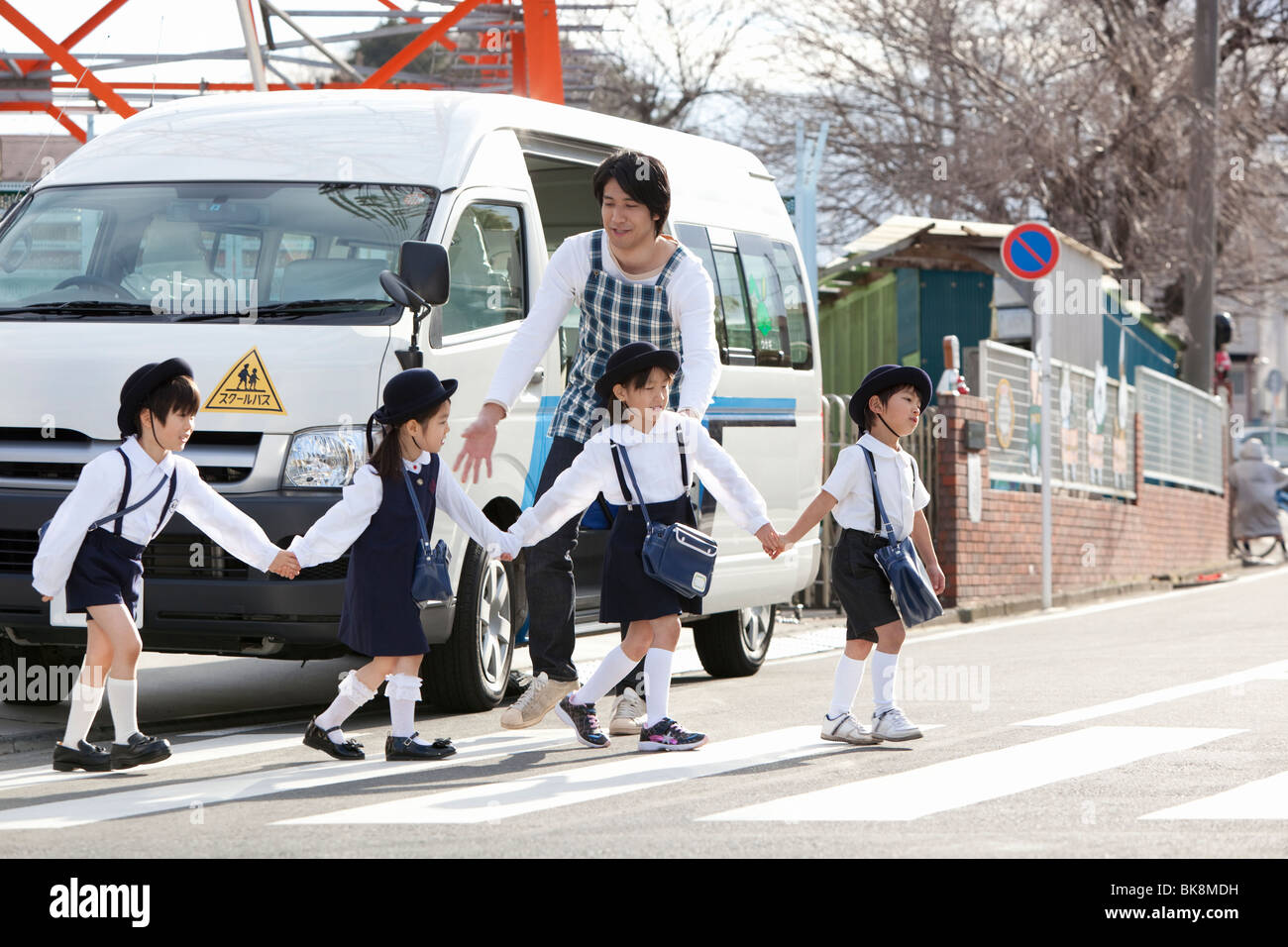 Kindergarten Teacher and Children Walking in front of School Bus Stock ...