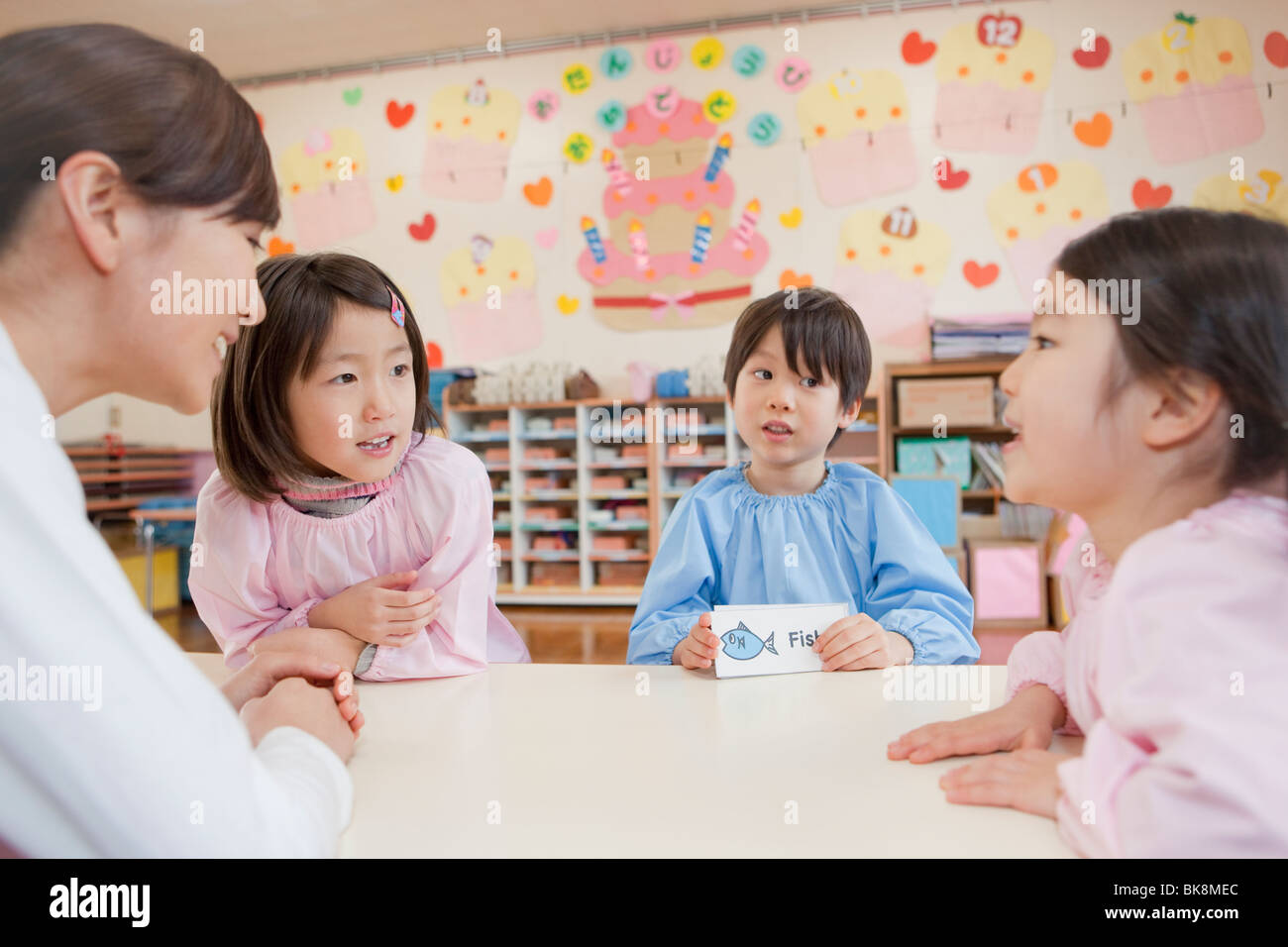 Kindergarten Teacher Teaching Children Stock Photo - Alamy