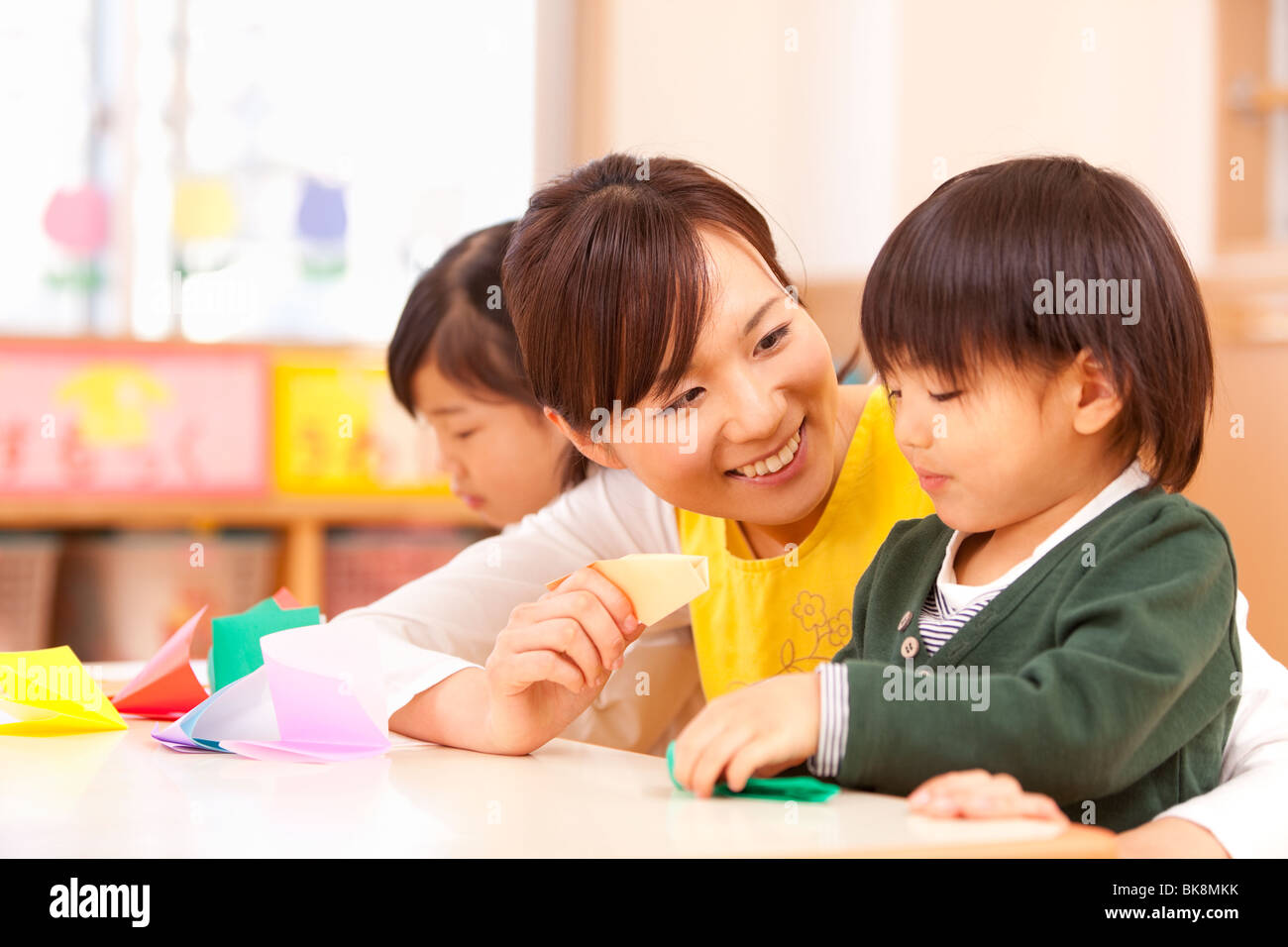 Nursery Teacher Talking to Children Stock Photo - Alamy