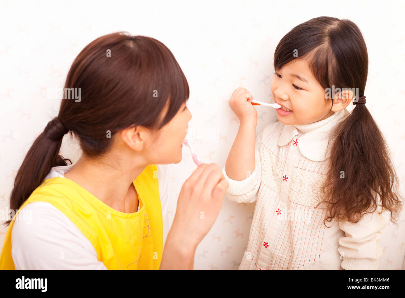 Nursery Teacher and Girl Brushing Teeth Stock Photo - Alamy