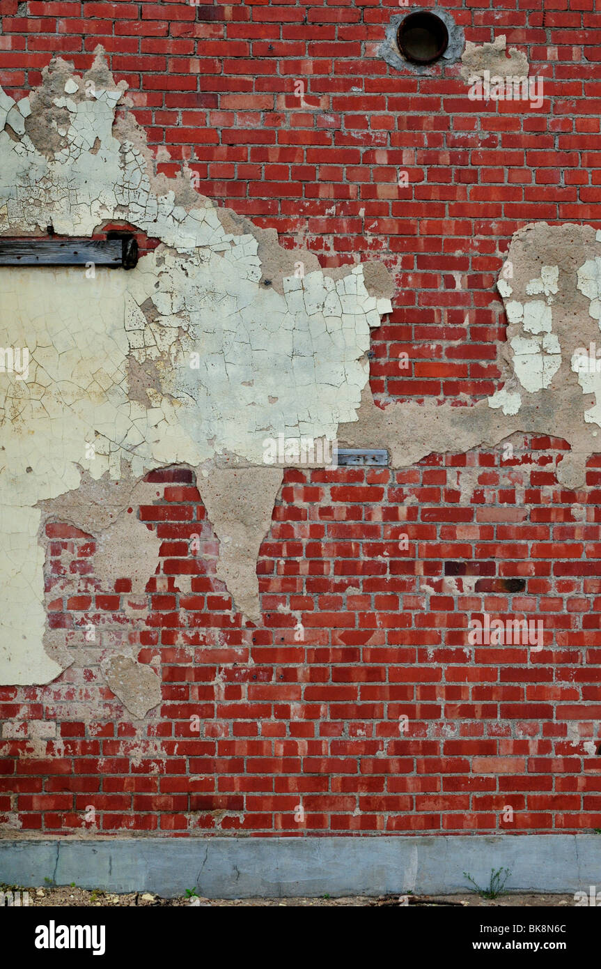 An old, red brick wall with cement patches. Suitable for backgrounds ...