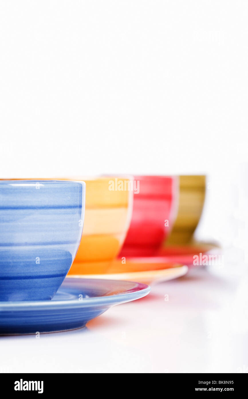 Four colourful tea cups in a line. Isolated. Foreground focus. Isolated ...