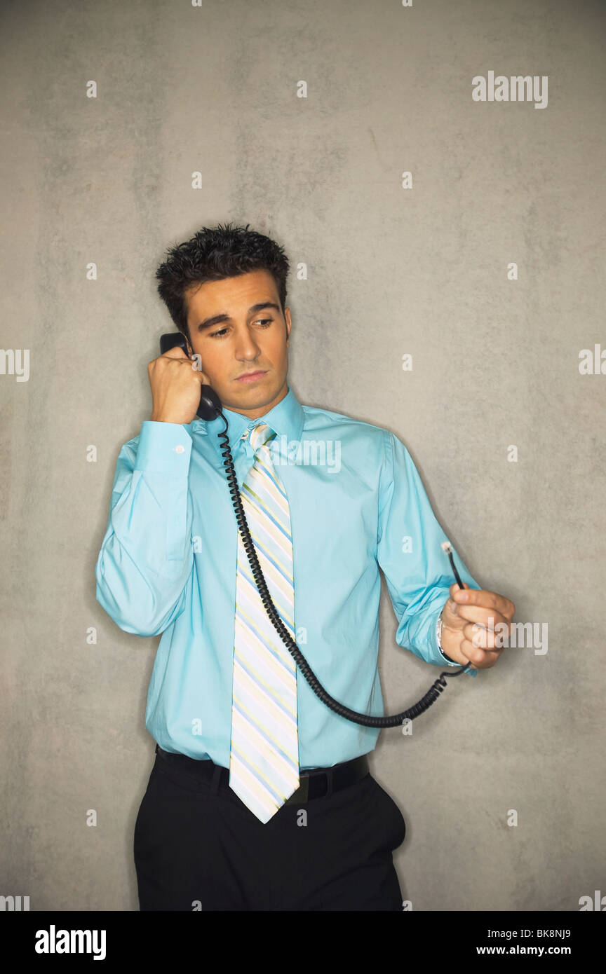 Businessman holding a telephone receiver Stock Photo - Alamy