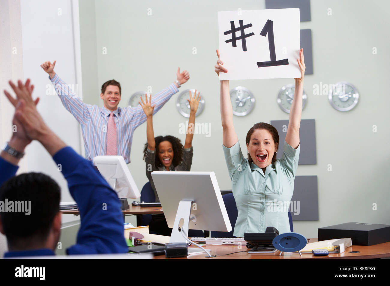 Office worker holding Number 1 sign Stock Photo - Alamy