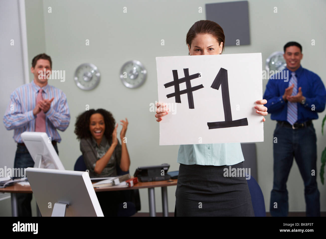 Office worker holding Number 1 sign Stock Photo - Alamy