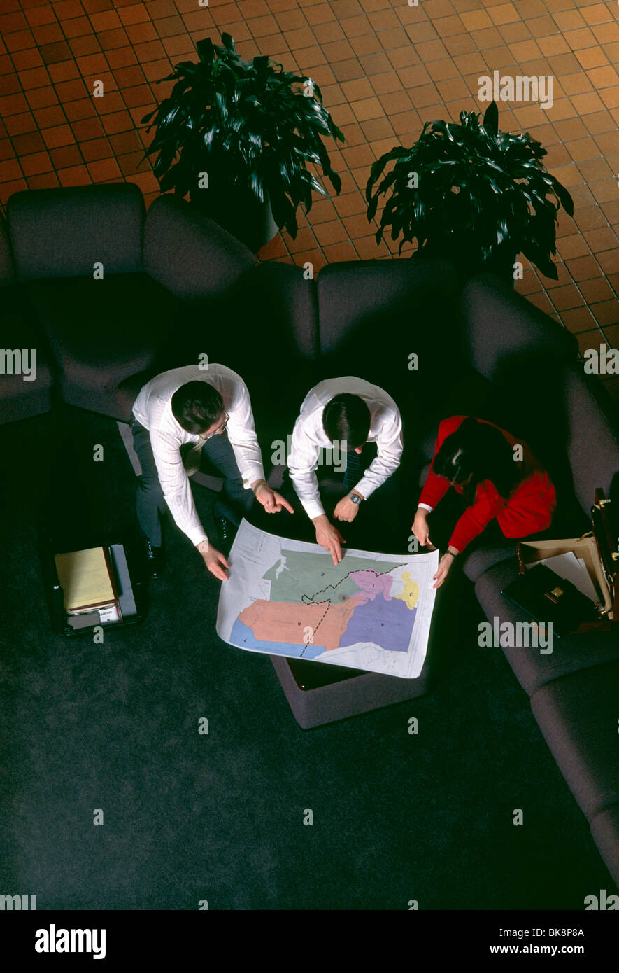 Overhead view of business people meeting in the upscale contemporary ...