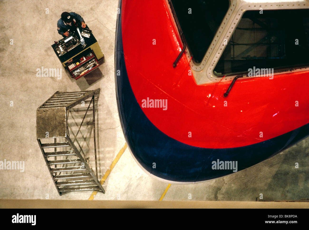 Overhead view of an aviation mechanic working on a jet at United ...