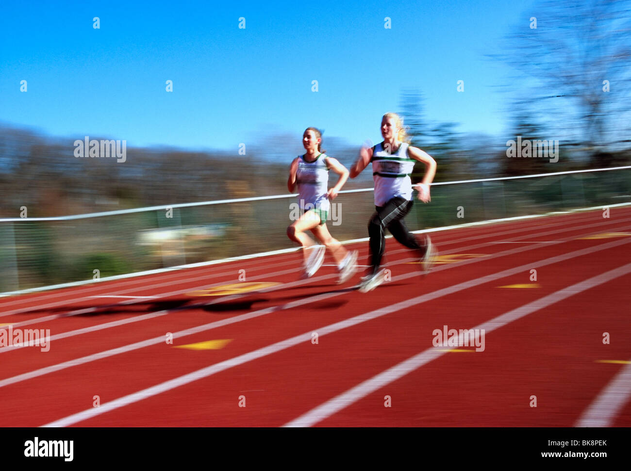 Blurred motion photograph of two high school track girls running on a ...