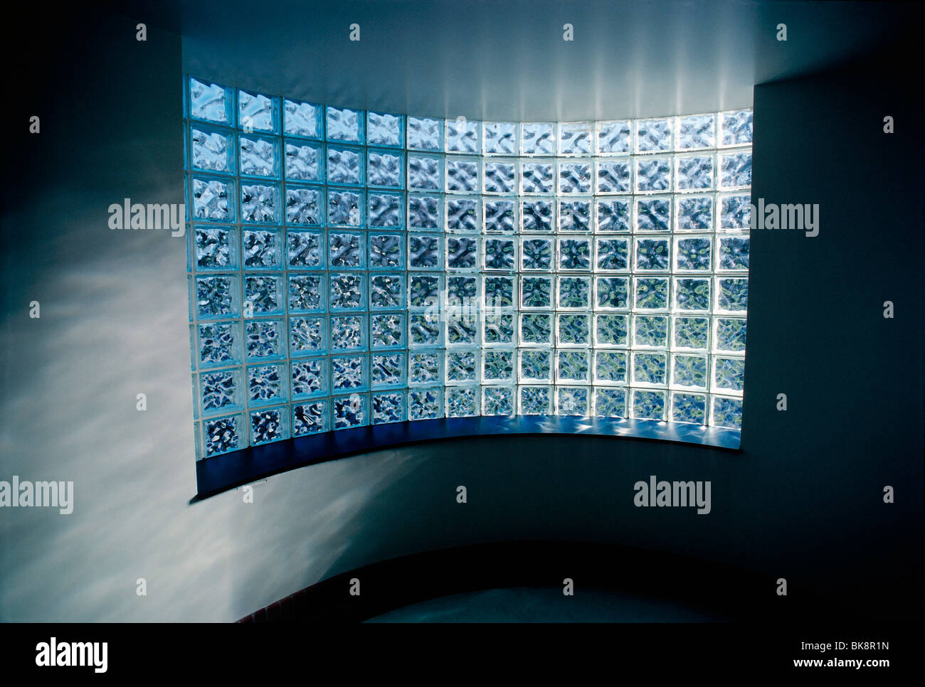 Sun streaming through block glass wall in a stairwell, American College ...