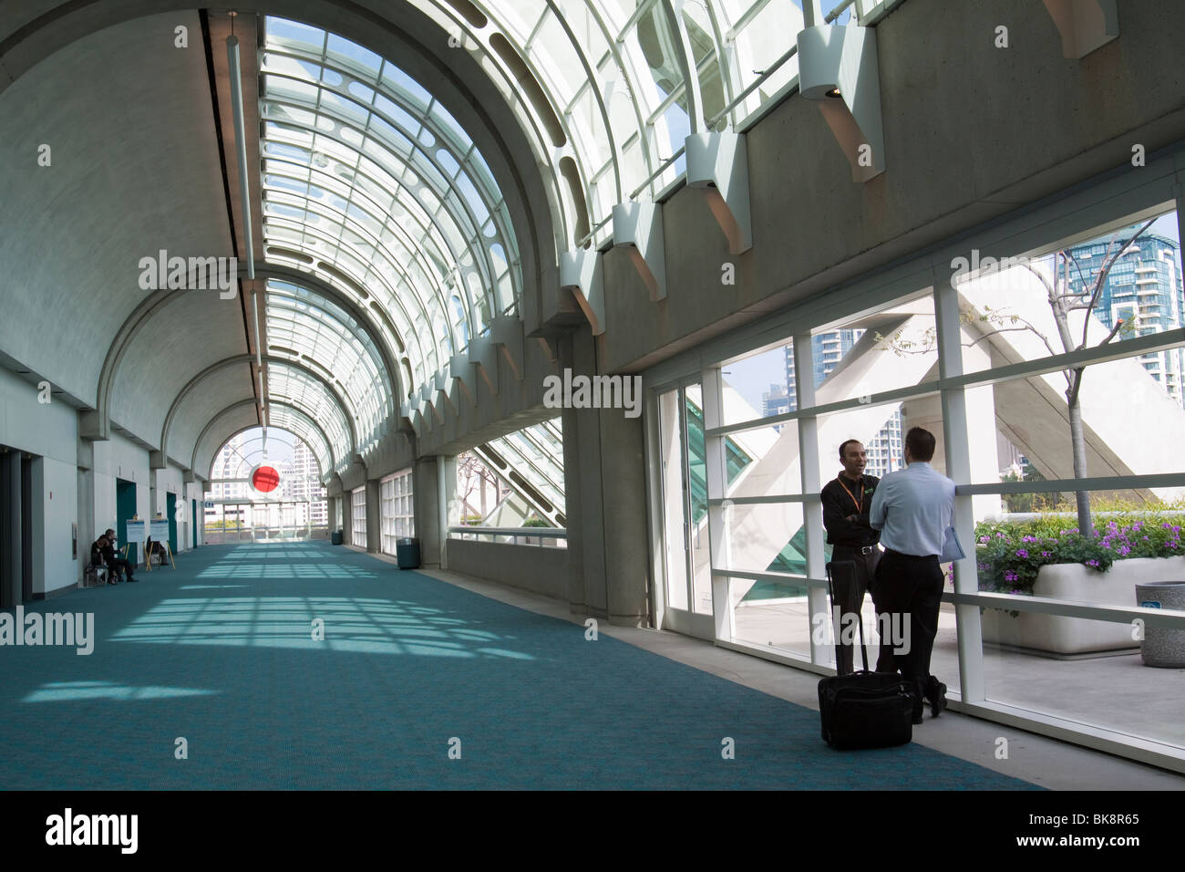 Business people chatting in a hallway in San Diego Convention Center ...