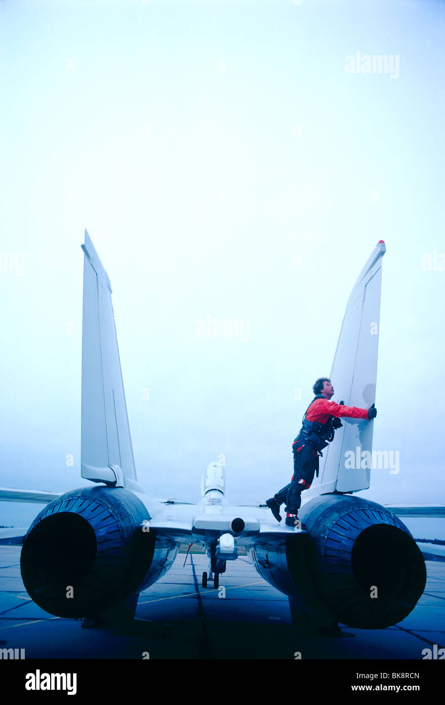 Aviation mechanic checking the rudder on a fighter jet at Northrup ...