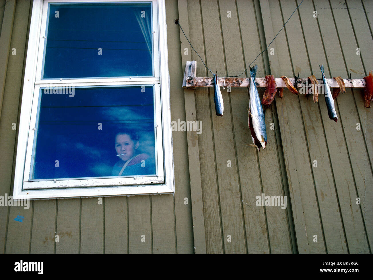 Local Inuit children photographed through a window of her home ...