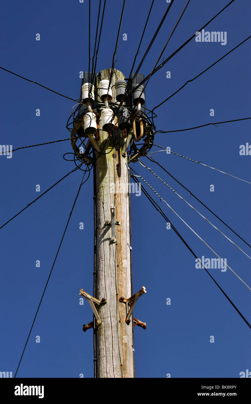 old style telephone pole with chandelier against a deep blue sky uk ...